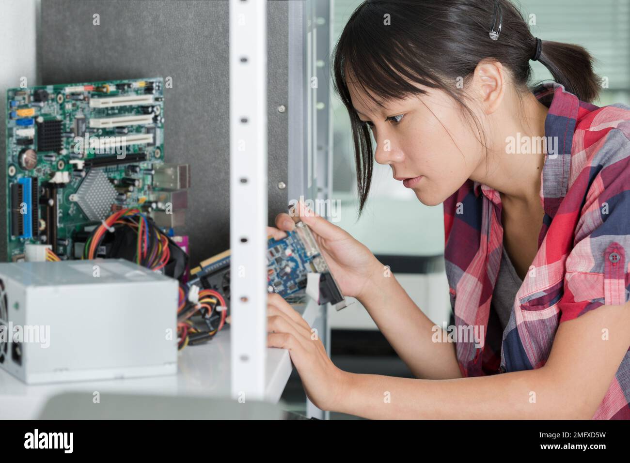 female engineer fixing broken computer hard drive Stock Photo - Alamy