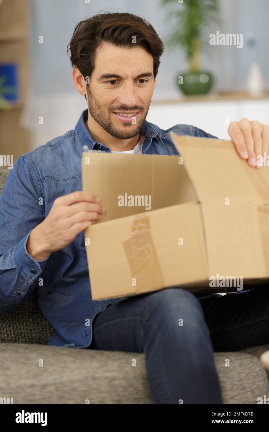 a man opening fragile parcel Stock Photo - Alamy