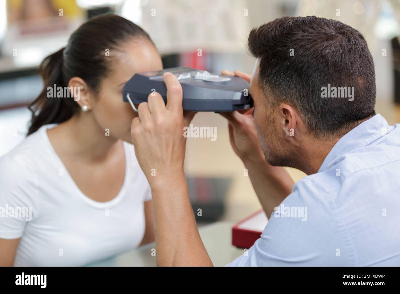 eye doctor with ophthalmologic binocular device Stock Photo - Alamy