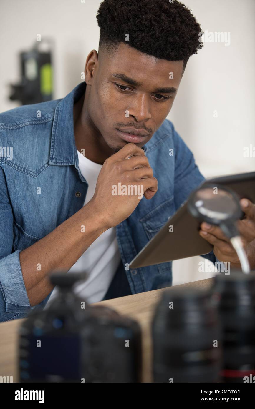 portrait of photographer checking his tablet Stock Photo - Alamy