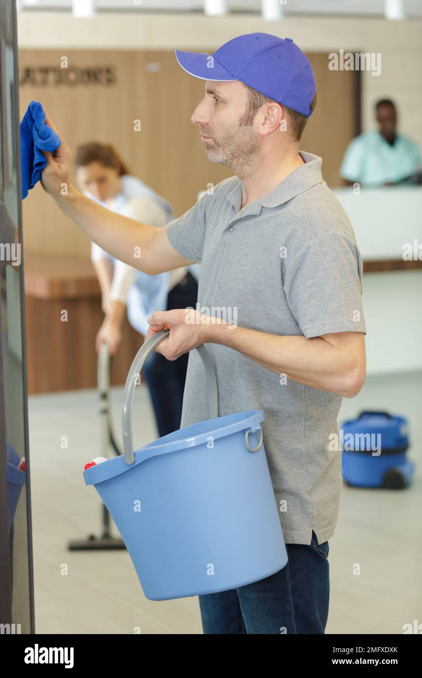 Man holding cleaning supplies hi-res stock photography and images - Alamy