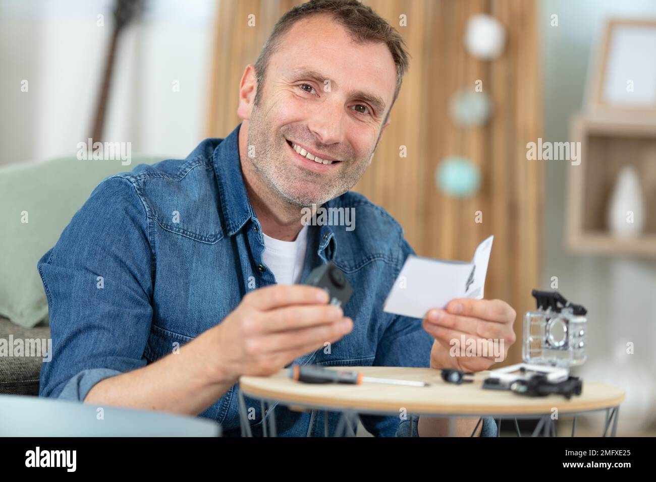 mature man happily doing diy at home Stock Photo - Alamy