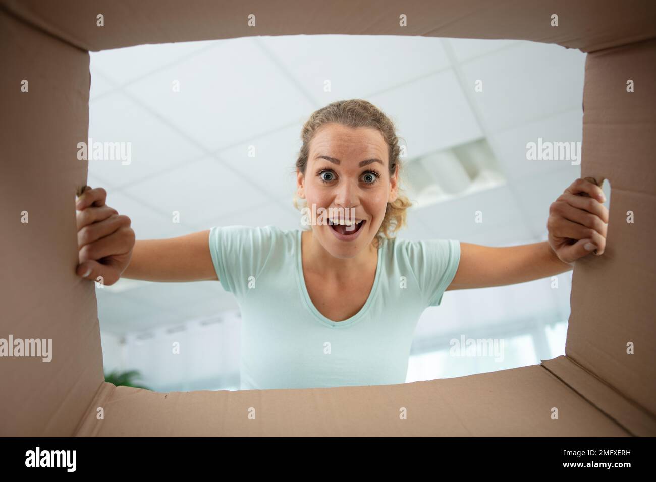 woman looks into empty parcel box Stock Photo - Alamy