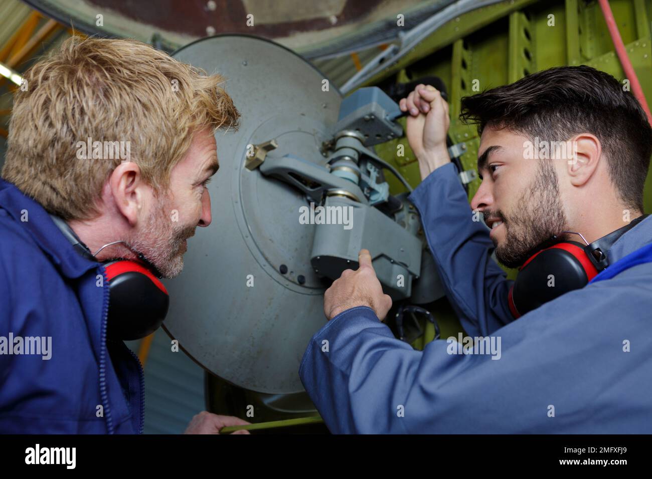 apprentice mechanic asking his supervisor a question Stock Photo - Alamy