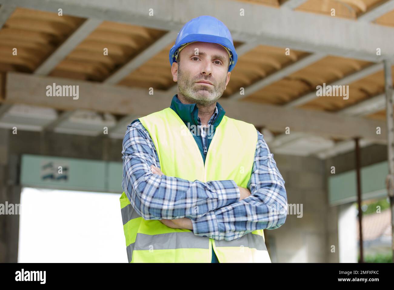 male engineer standing confidently with a crossed arms Stock Photo - Alamy
