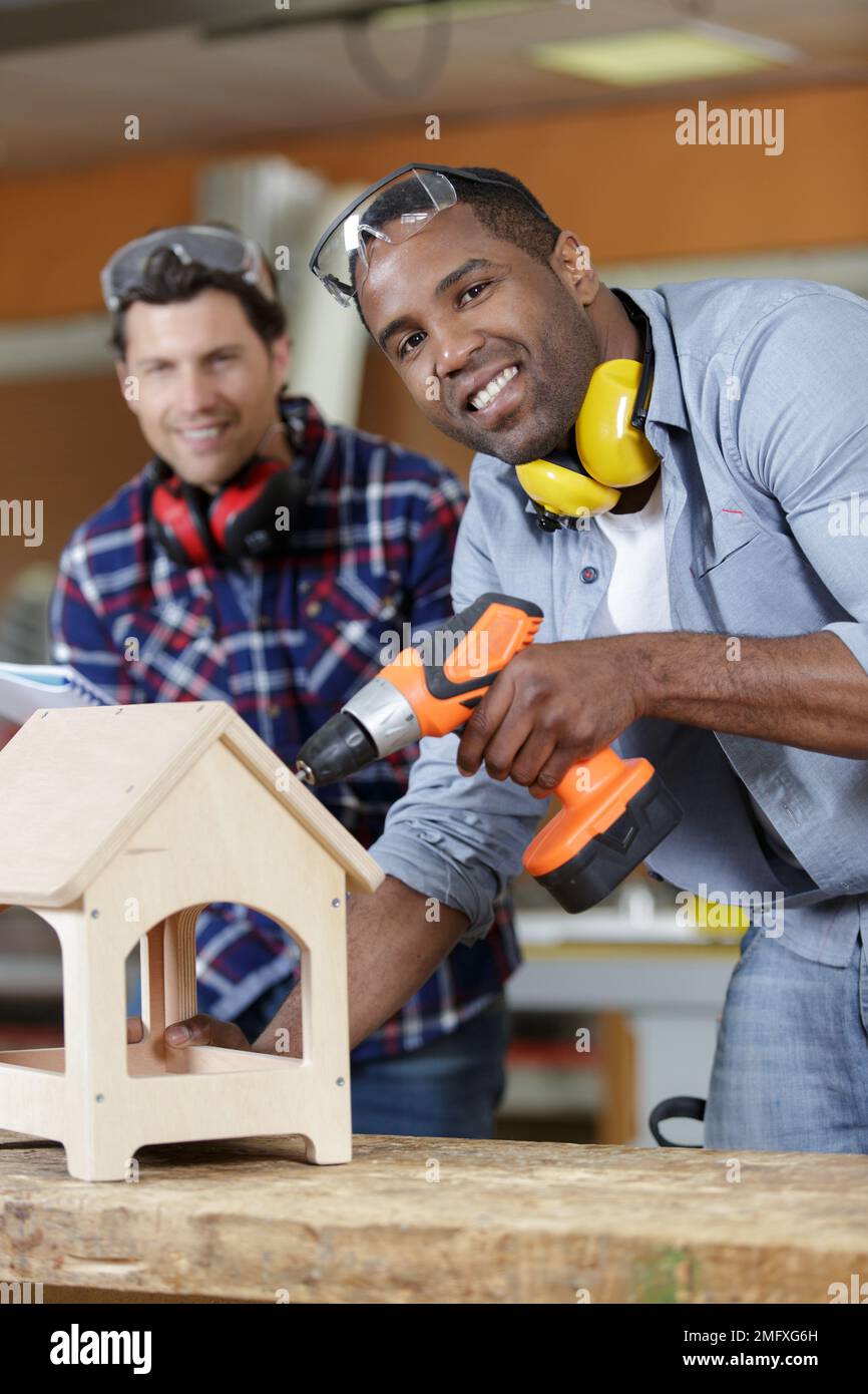 men workers behind drilling machine Stock Photo - Alamy