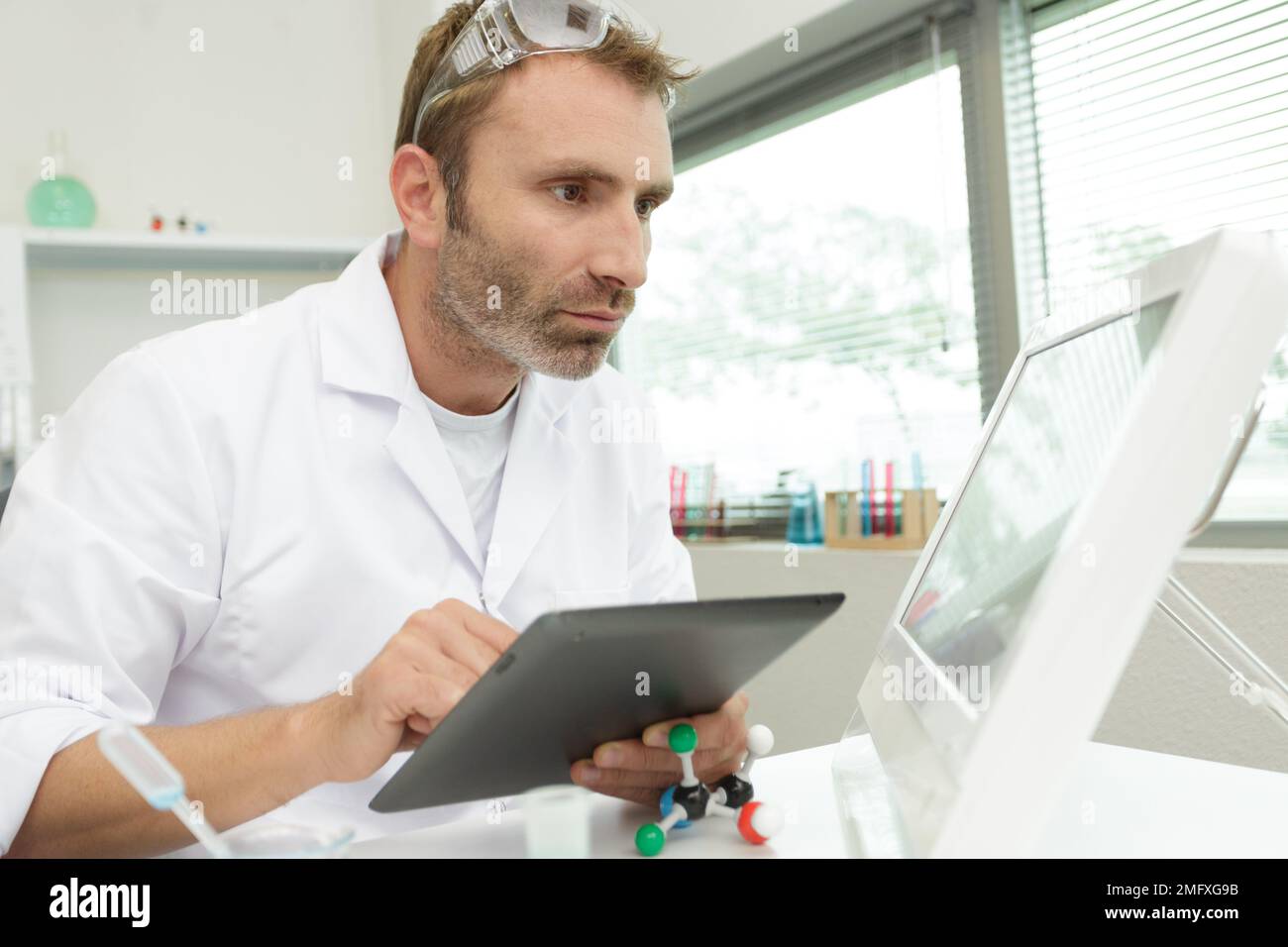 Indian man in lab coat with phone hi-res stock photography and images ...