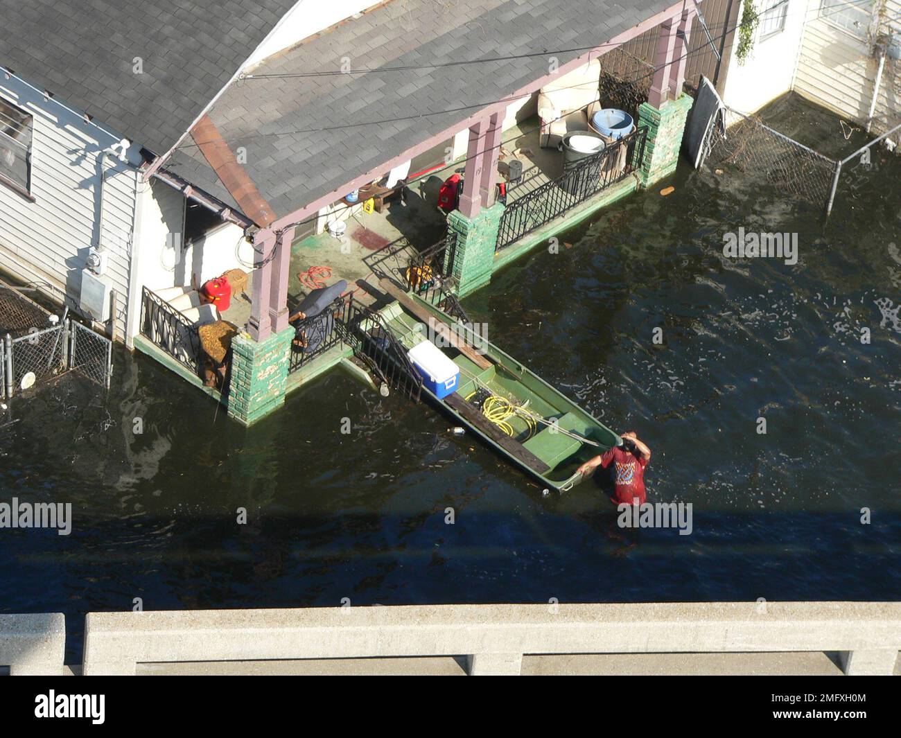 Aftermath - Flooding - Miscellaneous - 26-HK-36-330. man holding onto ...