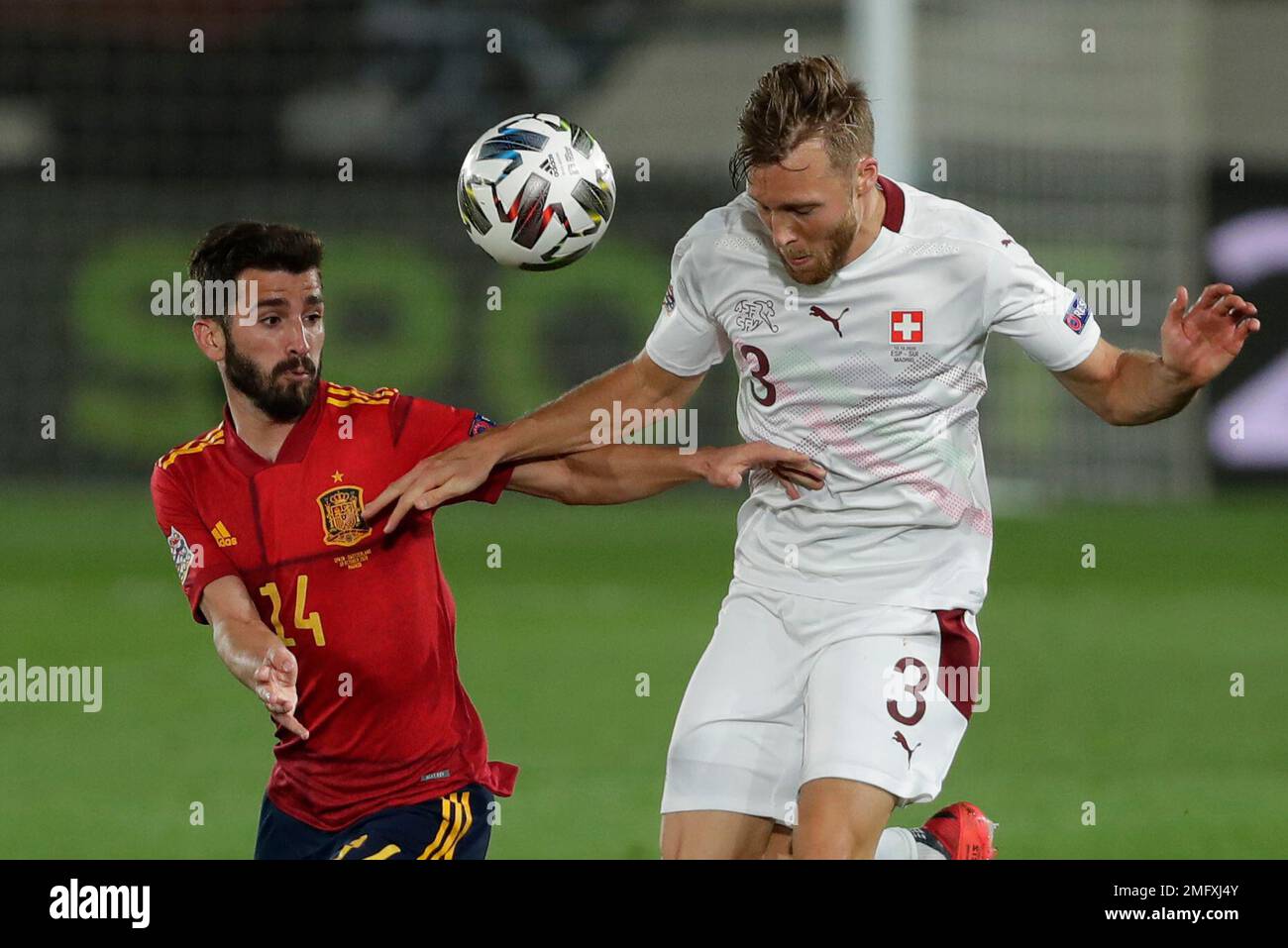 Spain's Jose Gaya, left vies for the ball with Switzerland's Silvan ...