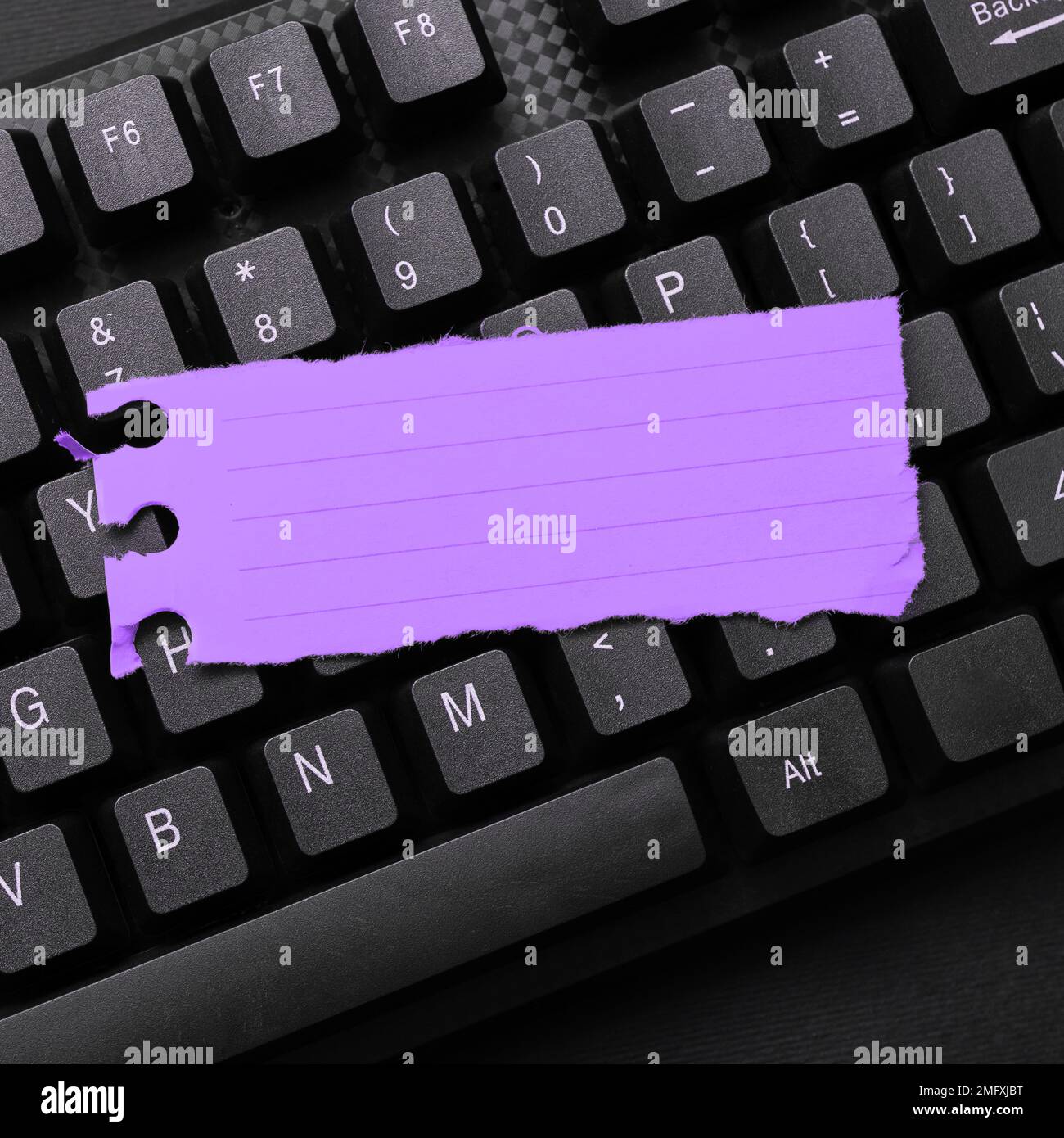 Colored sticker lying on black keyboard. Important information written ...