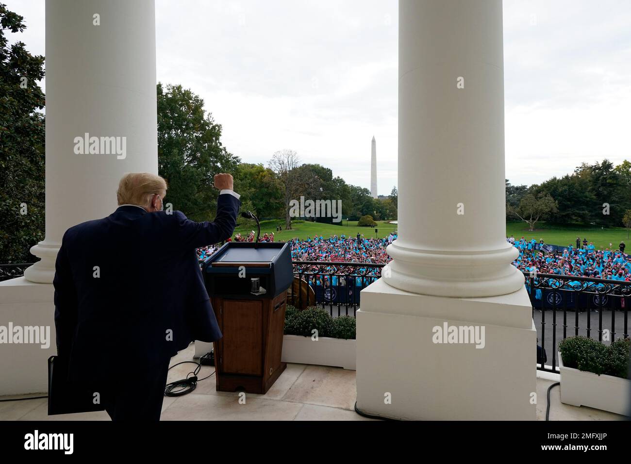 President Donald Trump gestures to a crowd of supporters from the Blue ...