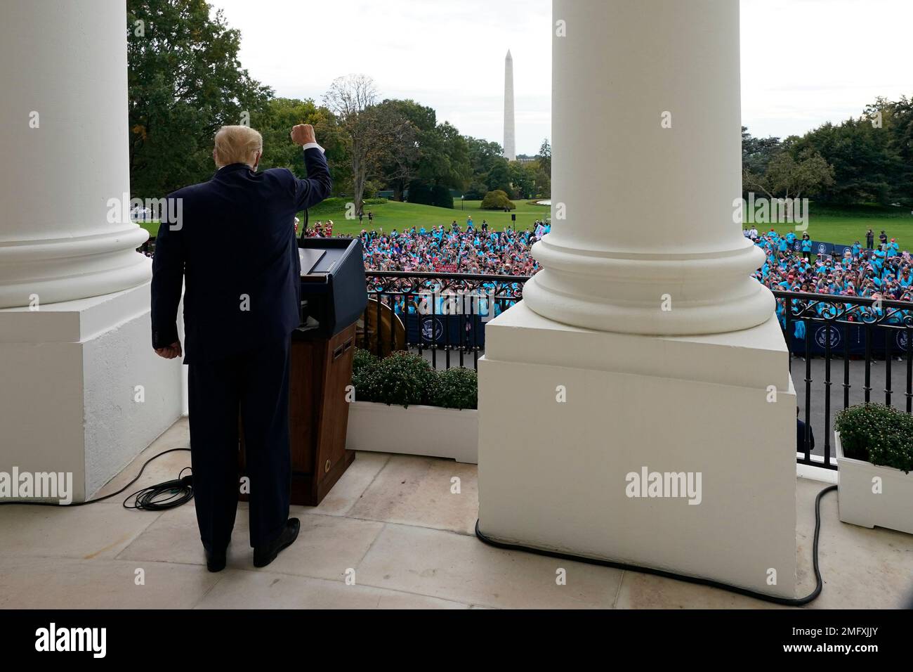 President Donald Trump gestures from the Blue Room Balcony of the White ...