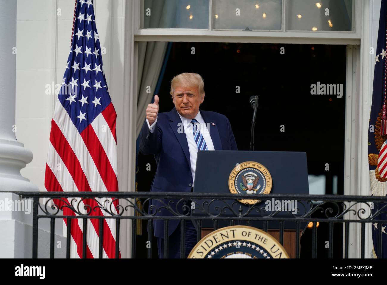 President Donald Trump gives a thumbs up from the Blue Room Balcony of ...