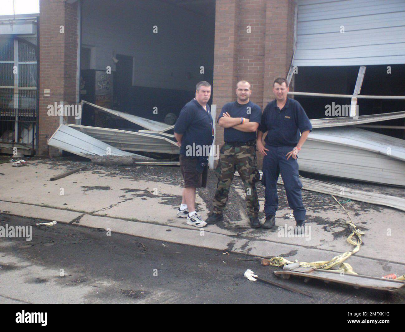 Aftermath - Miscellaneous - 26-HK-48-108. three personnel outside ...