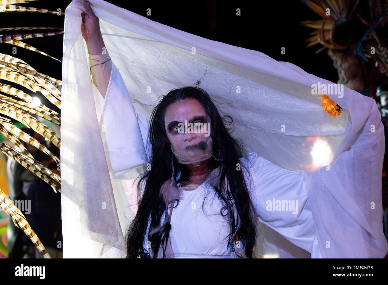 Actress Nayeli Cortes dressed as the La Llorona character, carries a ...