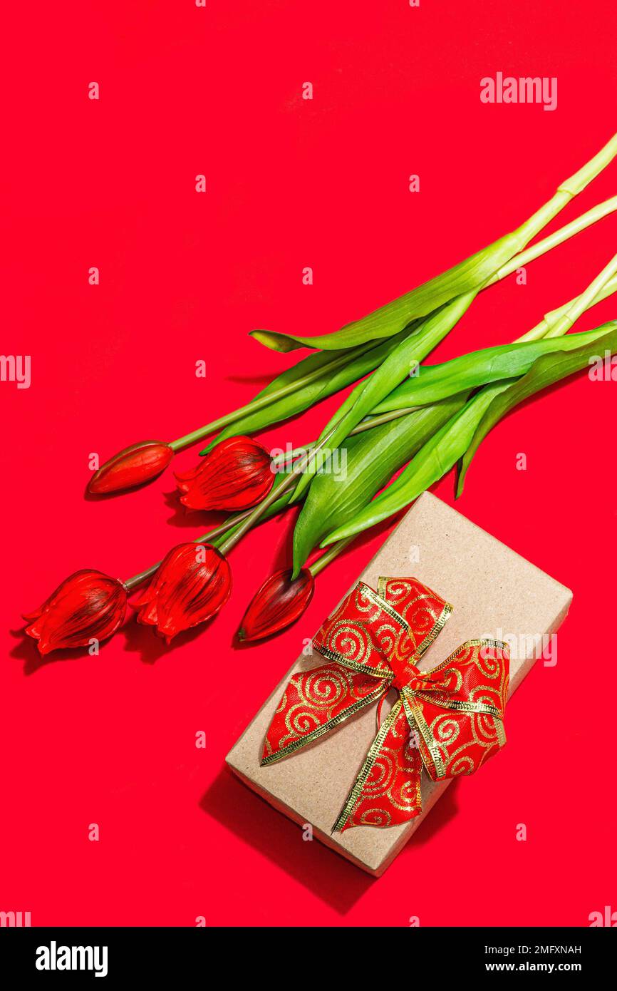 Valentine Day gift concept. Romantic red background with bright tulips ...