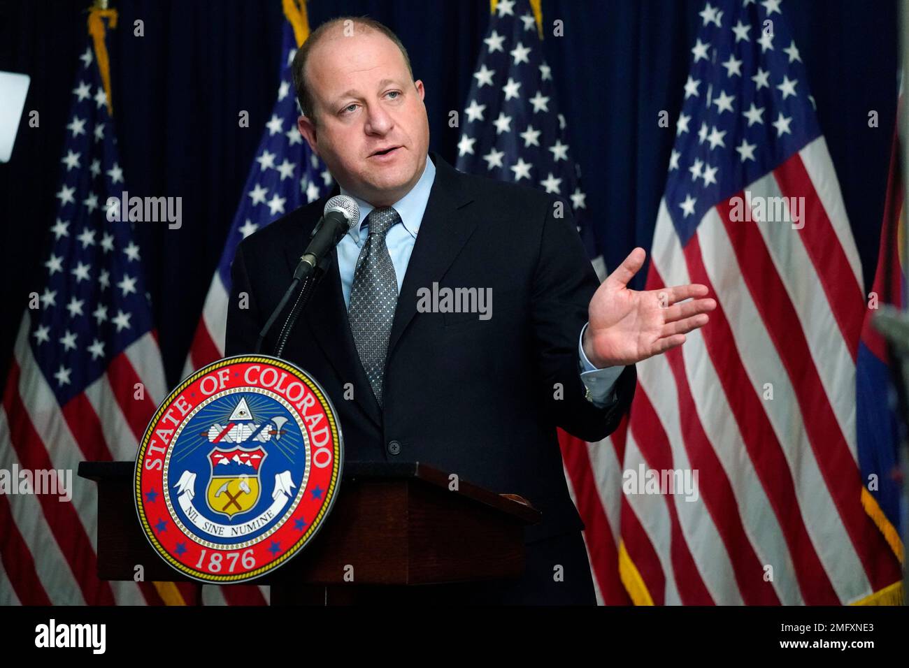 Colorado Governor Jared Polis makes a point during a news conference on ...