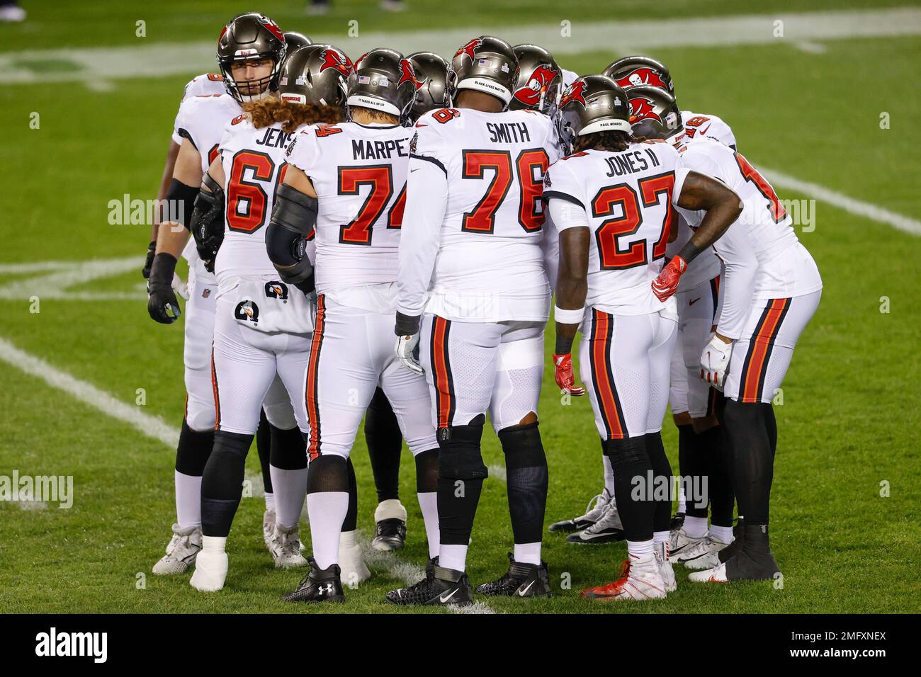 Tampa Bay Buccaneers players huddle during an NFL football game against ...