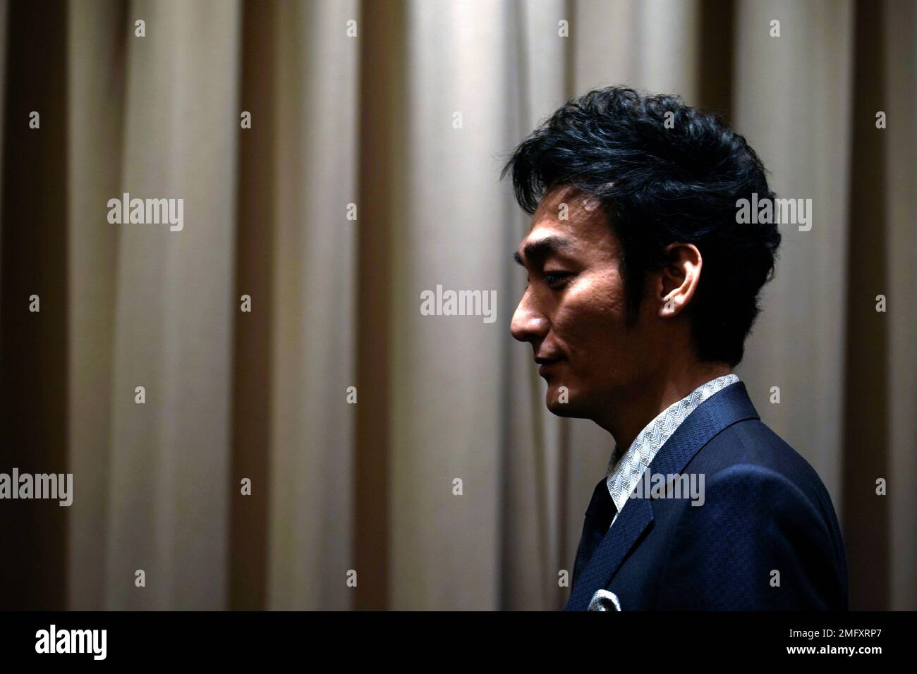 Former member of Japan's pop group SMAP Tsuyoshi Kusanagi walks after a ...