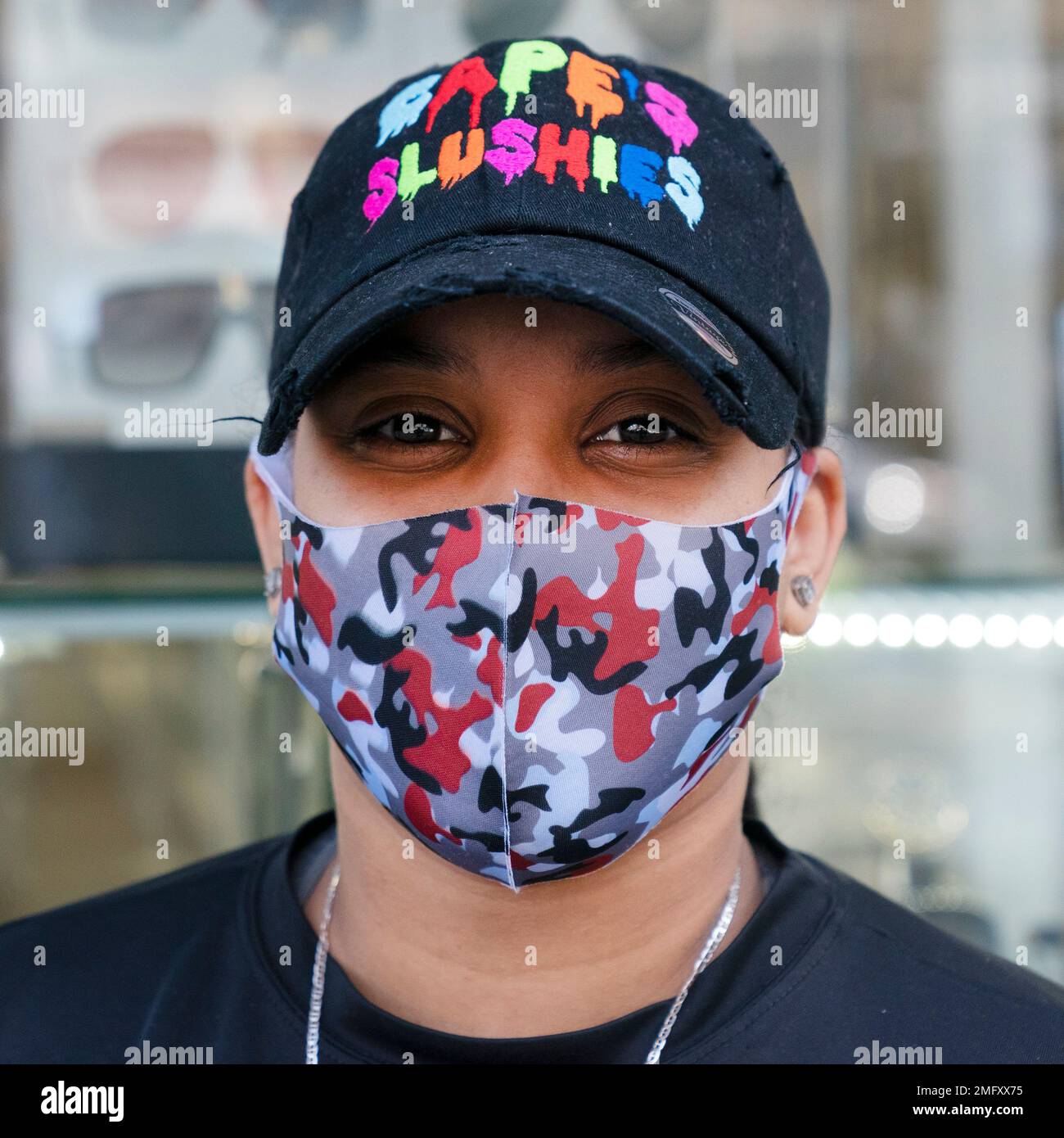 A woman poses with a multi-colored mask, Friday, Sept. 25, 2020 in New ...