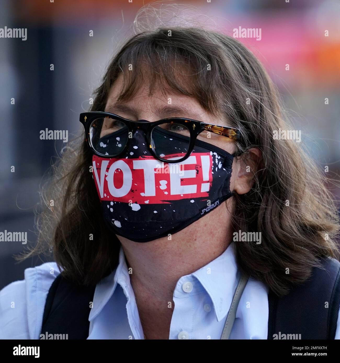 High school teacher Amanda Clarke wears her VOTE! mask as she arrives ...
