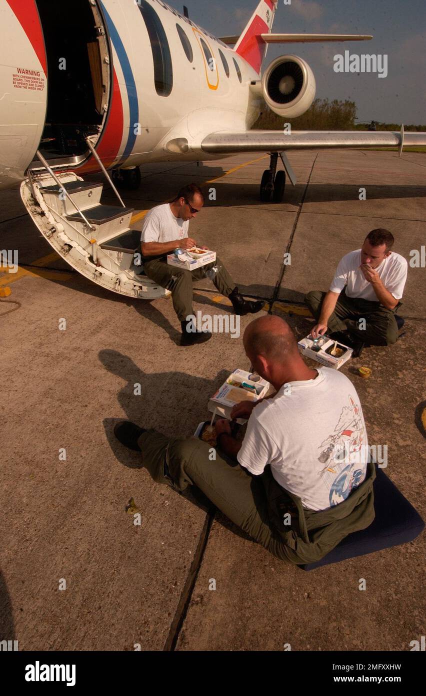 Aircrafts - HU-25 Guardian - 26-HK-55-2. Air crew eating meal on ramp ...