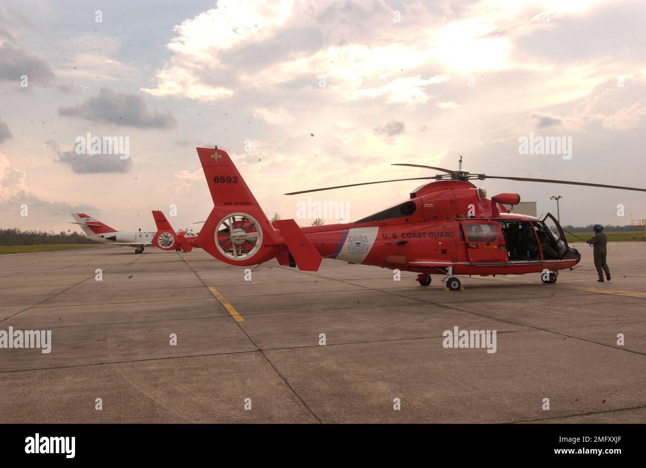 Aircrafts - HH-65 Dolphin - 26-HK-54-16. Coast Guardsman on ramp with ...