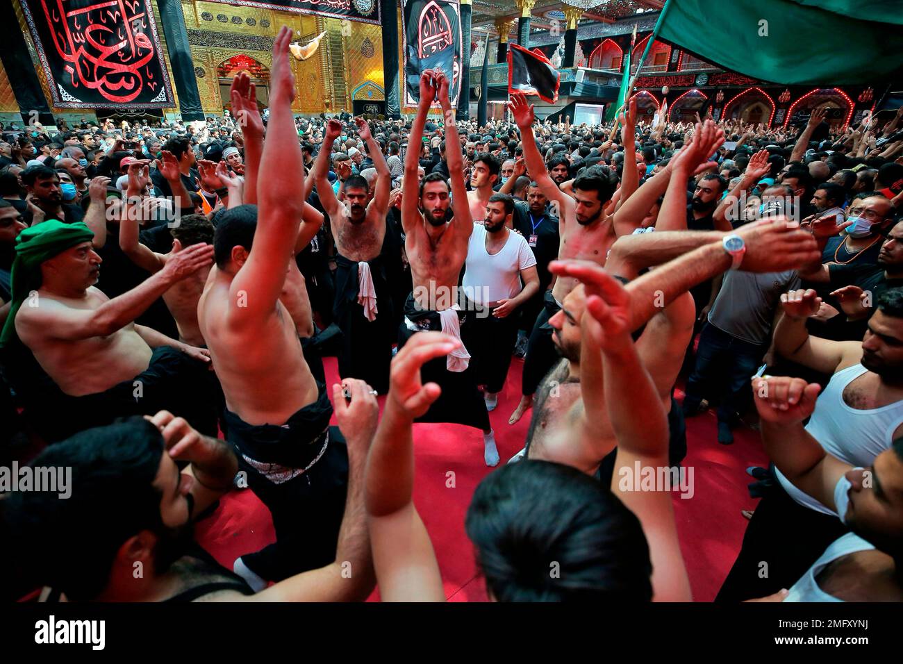 Shiite Muslims beat themselves as a sign of grief inside the holy ...