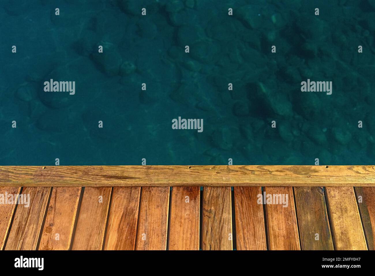 View of the wooden floor of the jetty and the blue sea in Kemer. Turkey ...