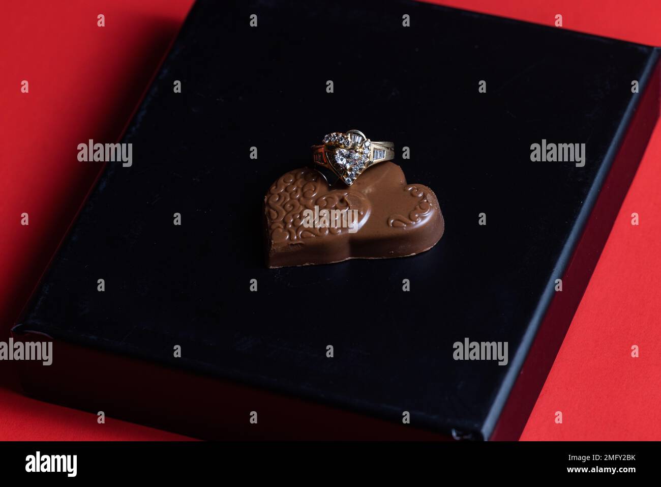 heart shaped ring with chocolates on a black box lid Stock Photo - Alamy