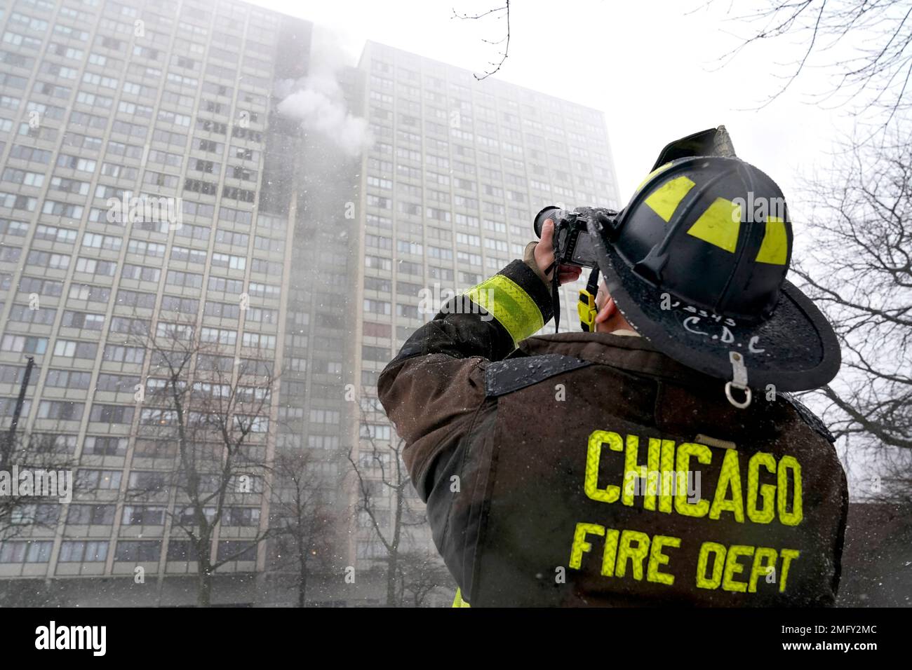 Chicago Fire Department Lt. C. Collins photographs the Harper Square ...