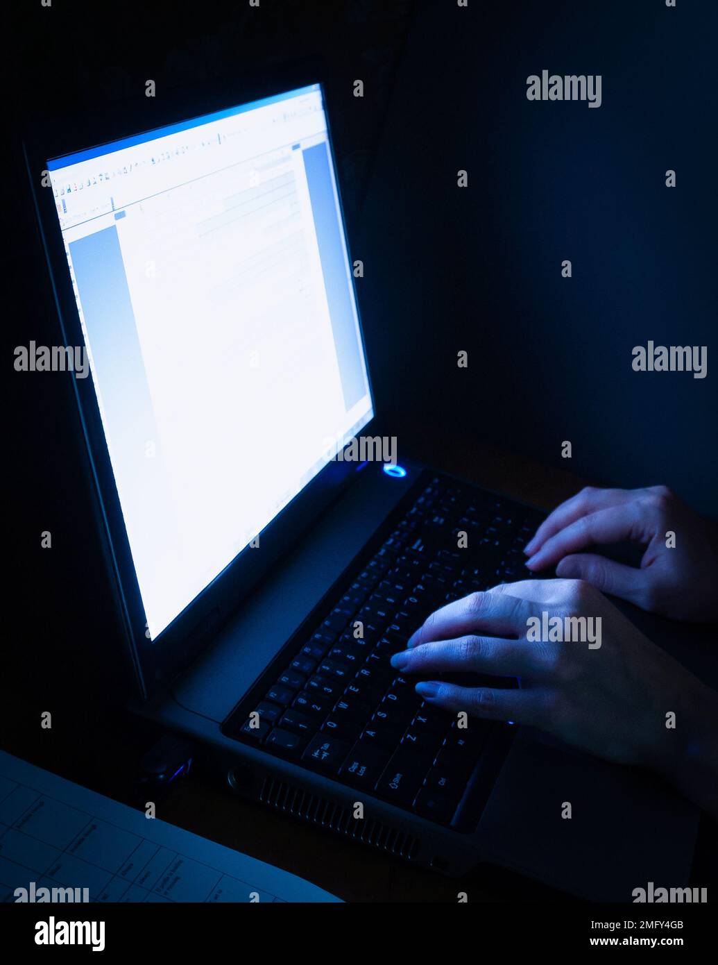 female hands typing work on a pc laptop computer in dark Stock Photo ...