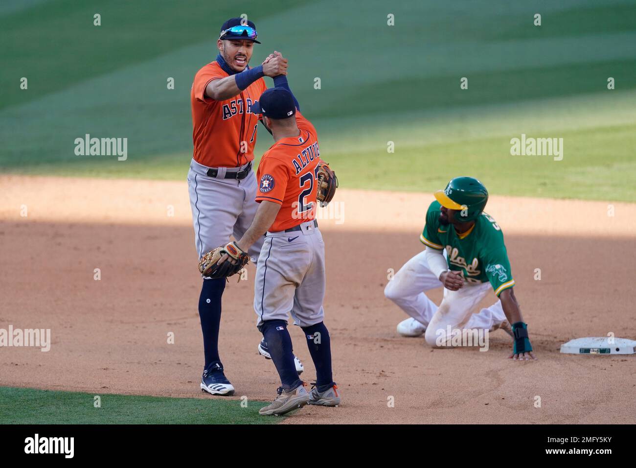 Houston Astros' Carlos Correa, left, and Jose Altuve celebrate in front ...