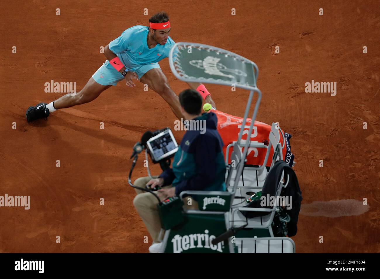 Spain's Rafael Nadal plays a shot from behind the umpire's chair in the ...
