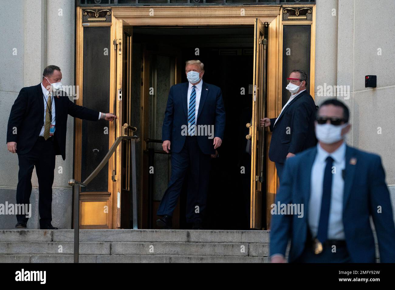 President Donald Trump walks out of Walter Reed National Military ...