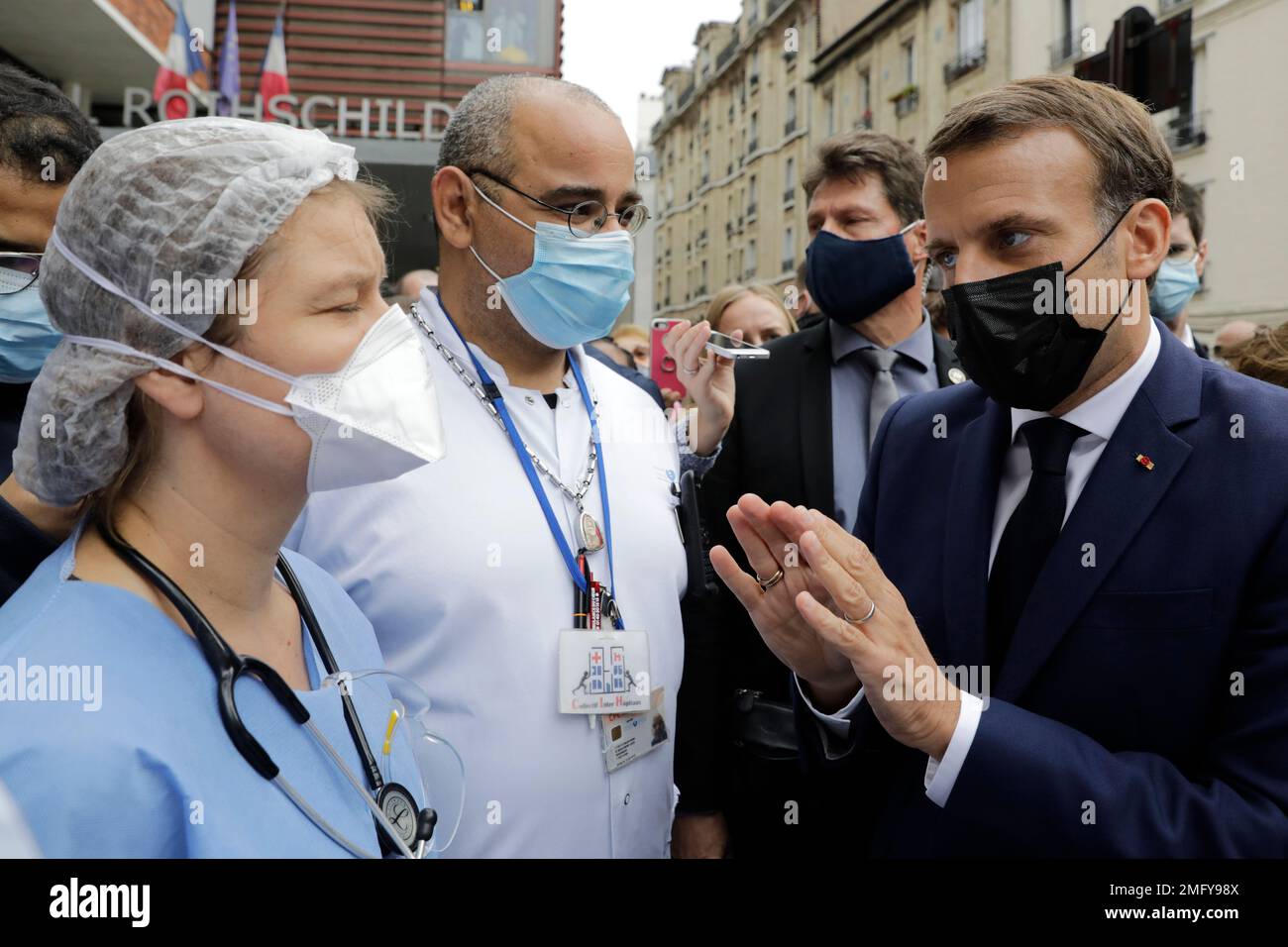 French President Emmanuel Macron, right, meets medical workers of the ...