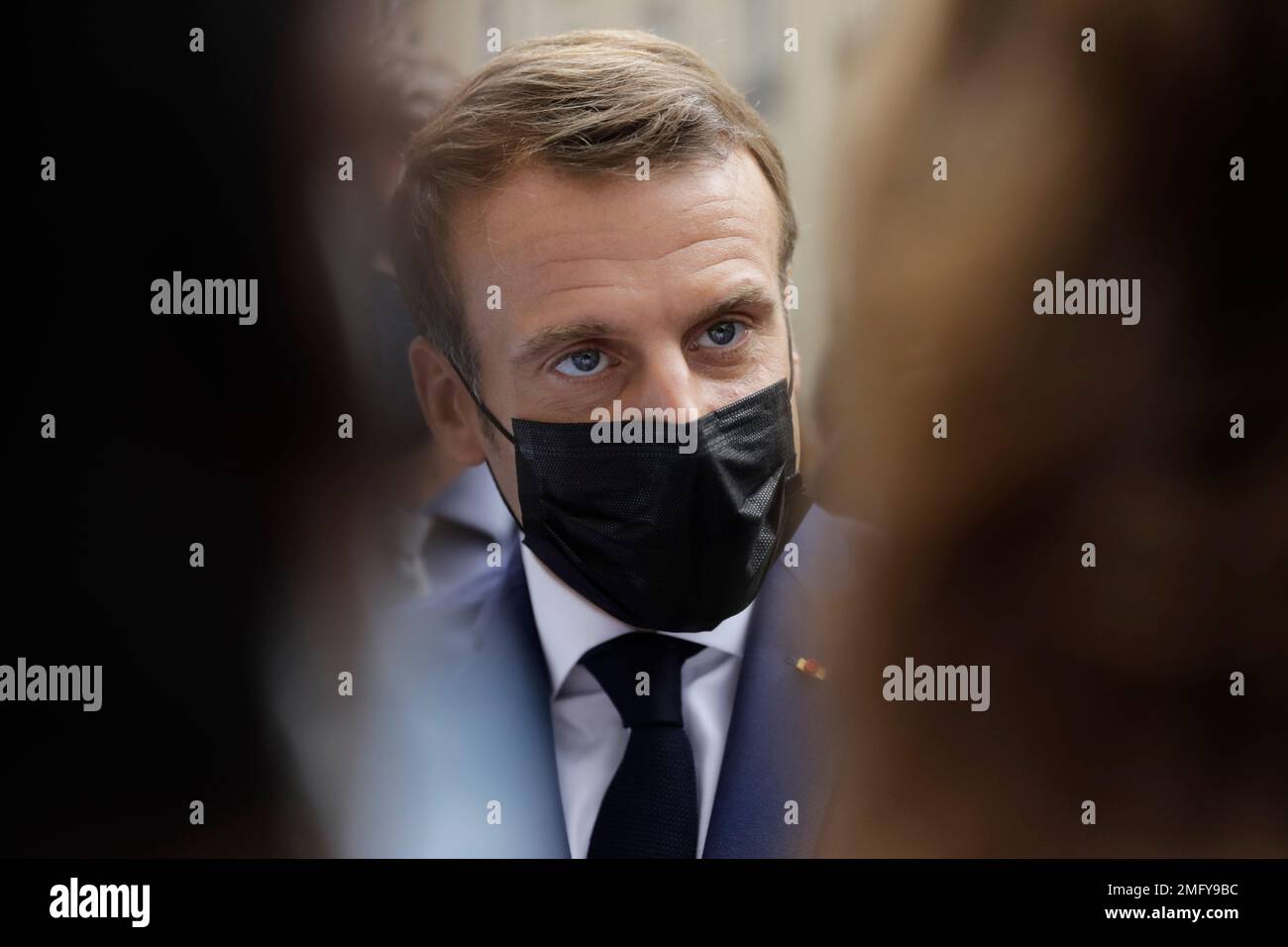 French President Emmanuel Macron talks to medical workers of the ...