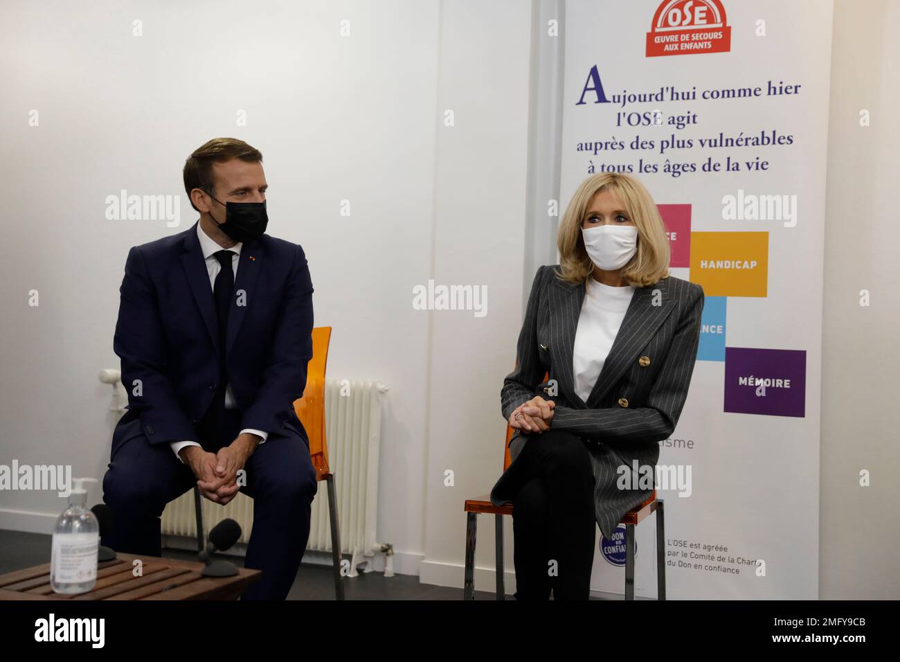 French President Emmanuel Macron and his wife Brigitte Macron talk to ...