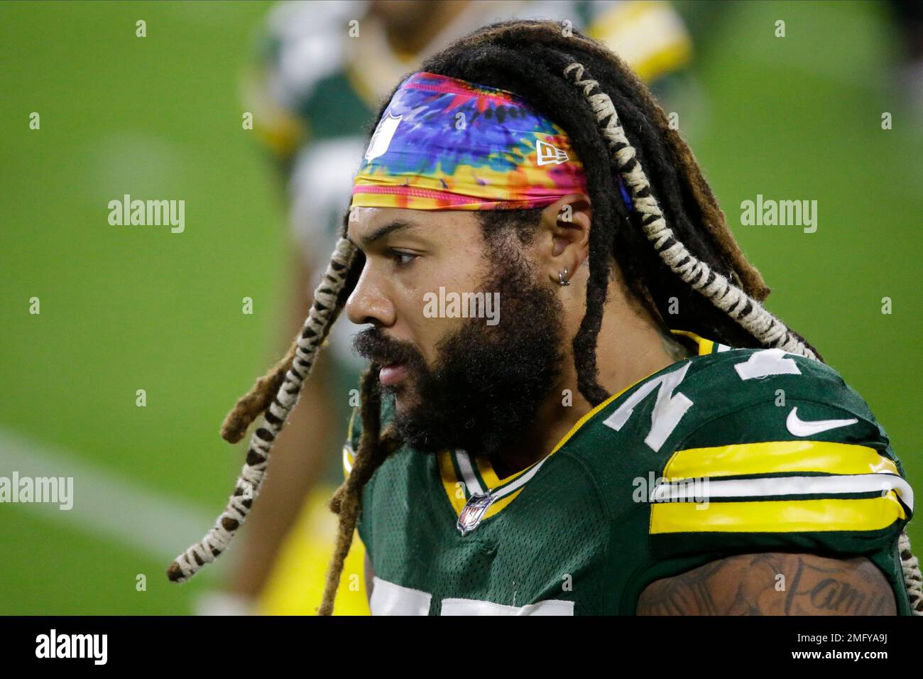 Green Bay Packers' Billy Turner wear a Crucial Catch headband as he ...
