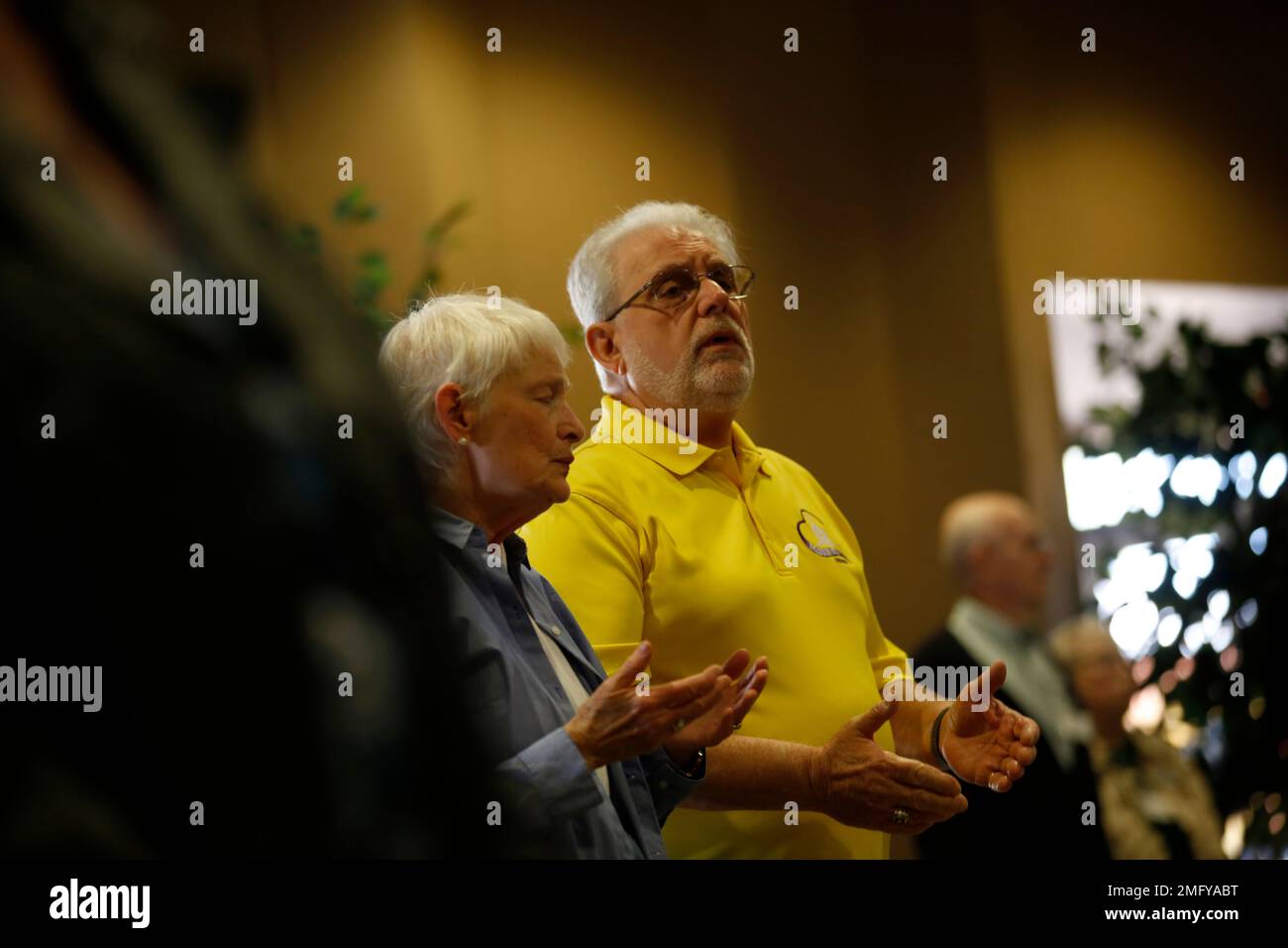 Marshall Militano and his wife, Sarah, pray at the Mission Bell United ...
