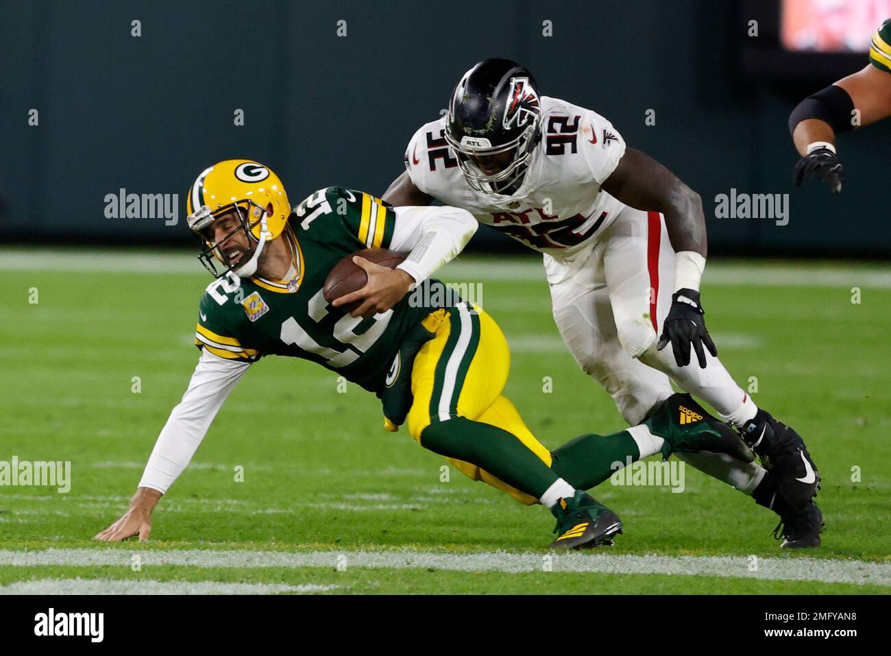 Green Bay Packers quarterback Aaron Rodgers (12) is tackled by Atlanta ...