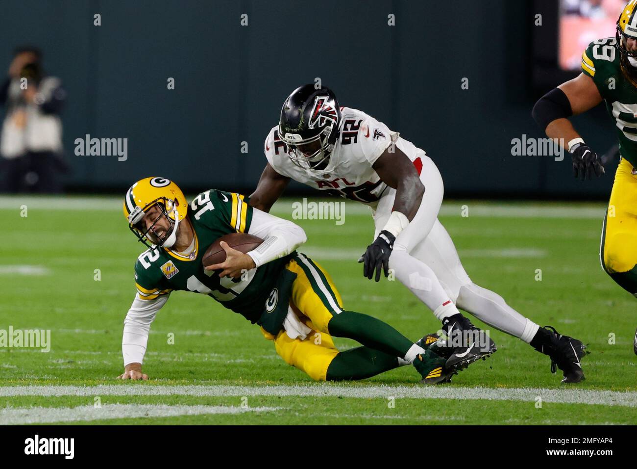 Green Bay Packers quarterback Aaron Rodgers (12) is tackled by Atlanta ...