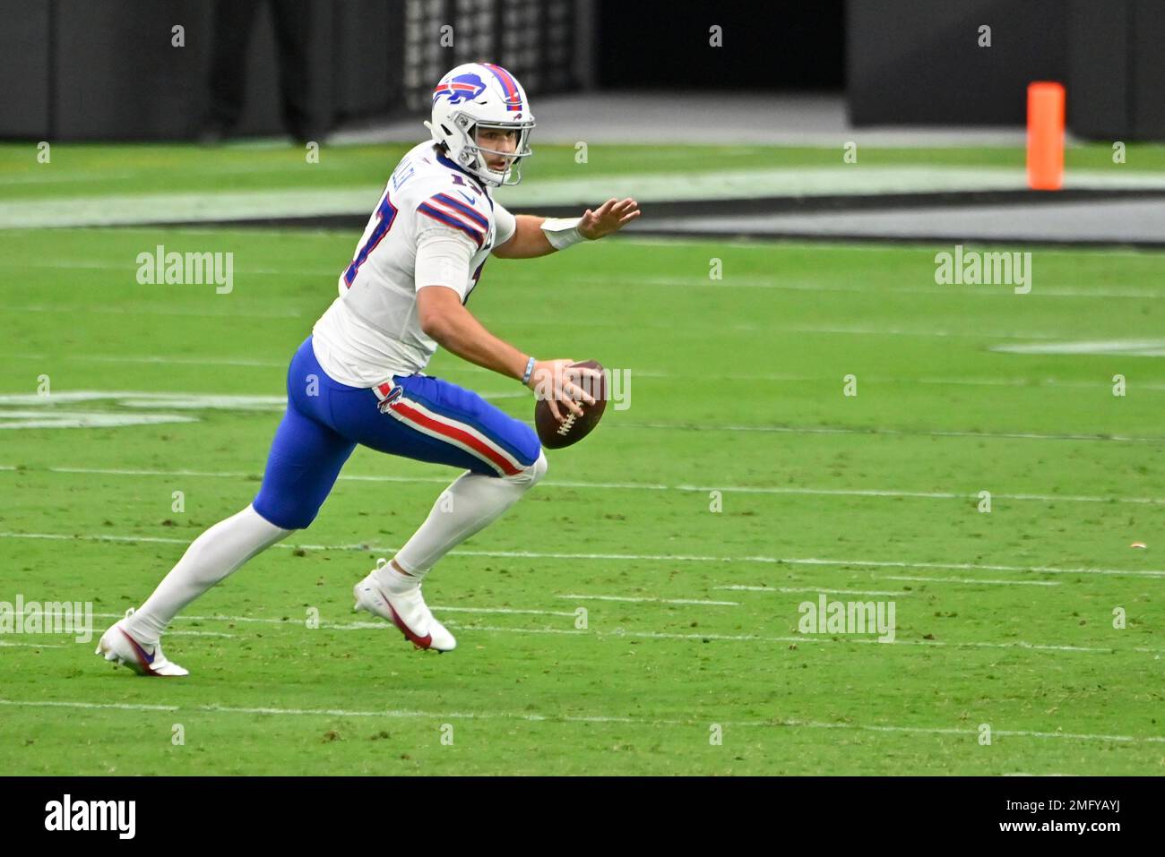 Buffalo Bills quarterback Josh Allen (17) scrambles with the ball of an ...