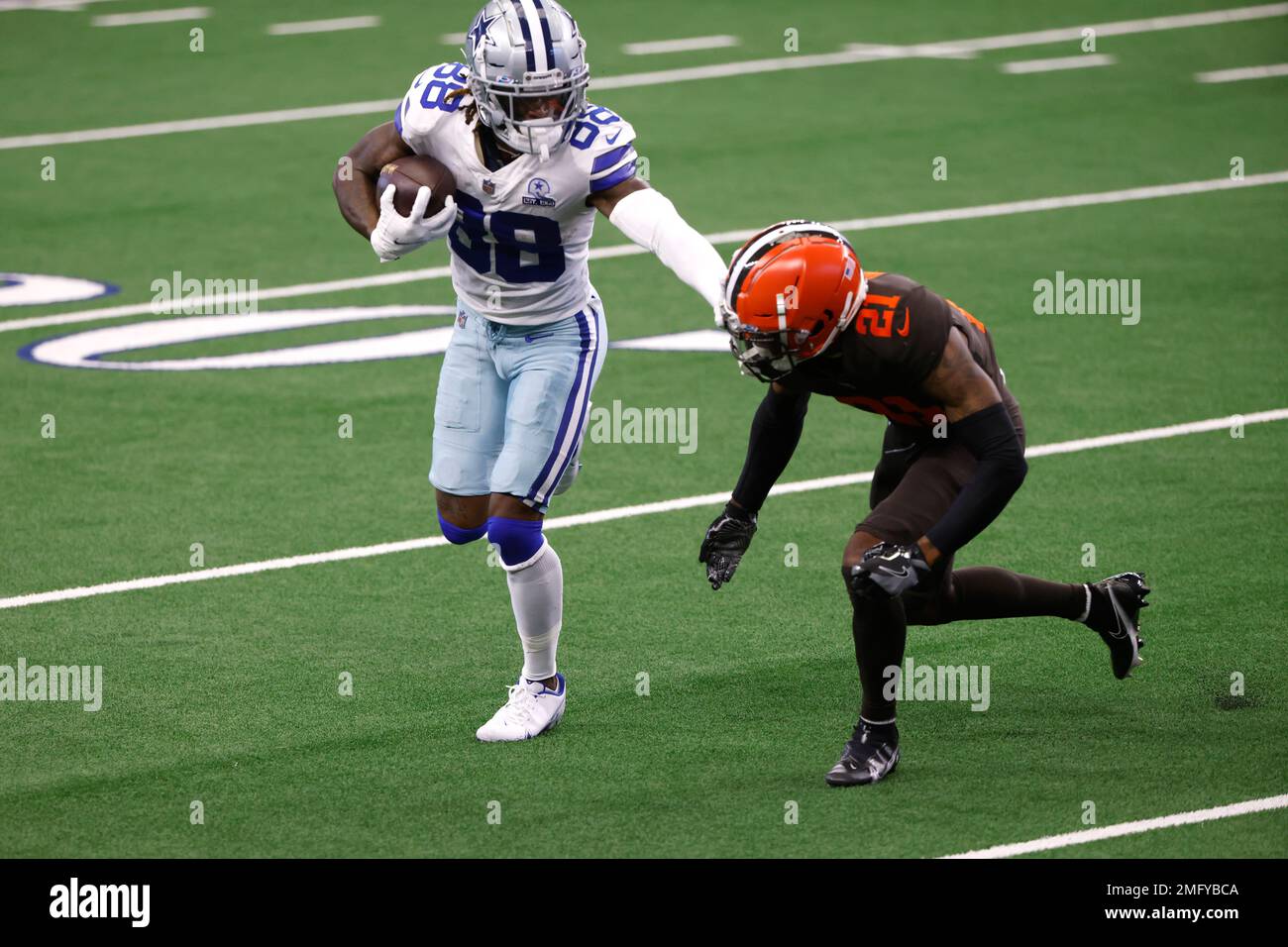 Dallas Cowboys wide receiver CeeDee Lamb (88) stiff arms Cleveland ...