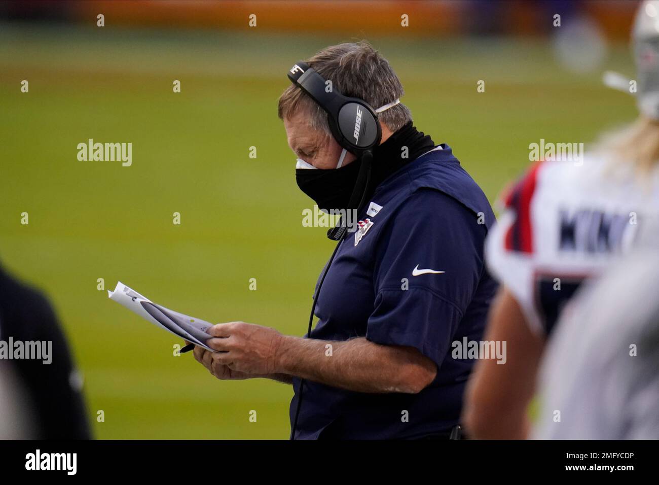 New England Patriots head coach Bill Belichick checks his play chart ...