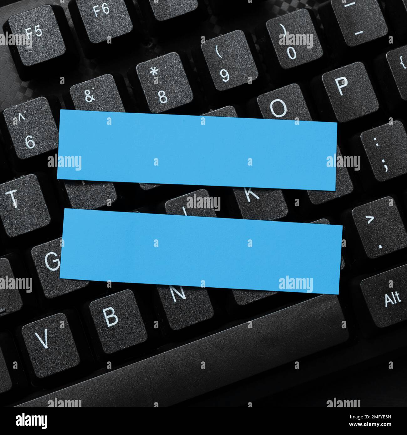 Sticker lying on black keyboard. Important message written over paper ...