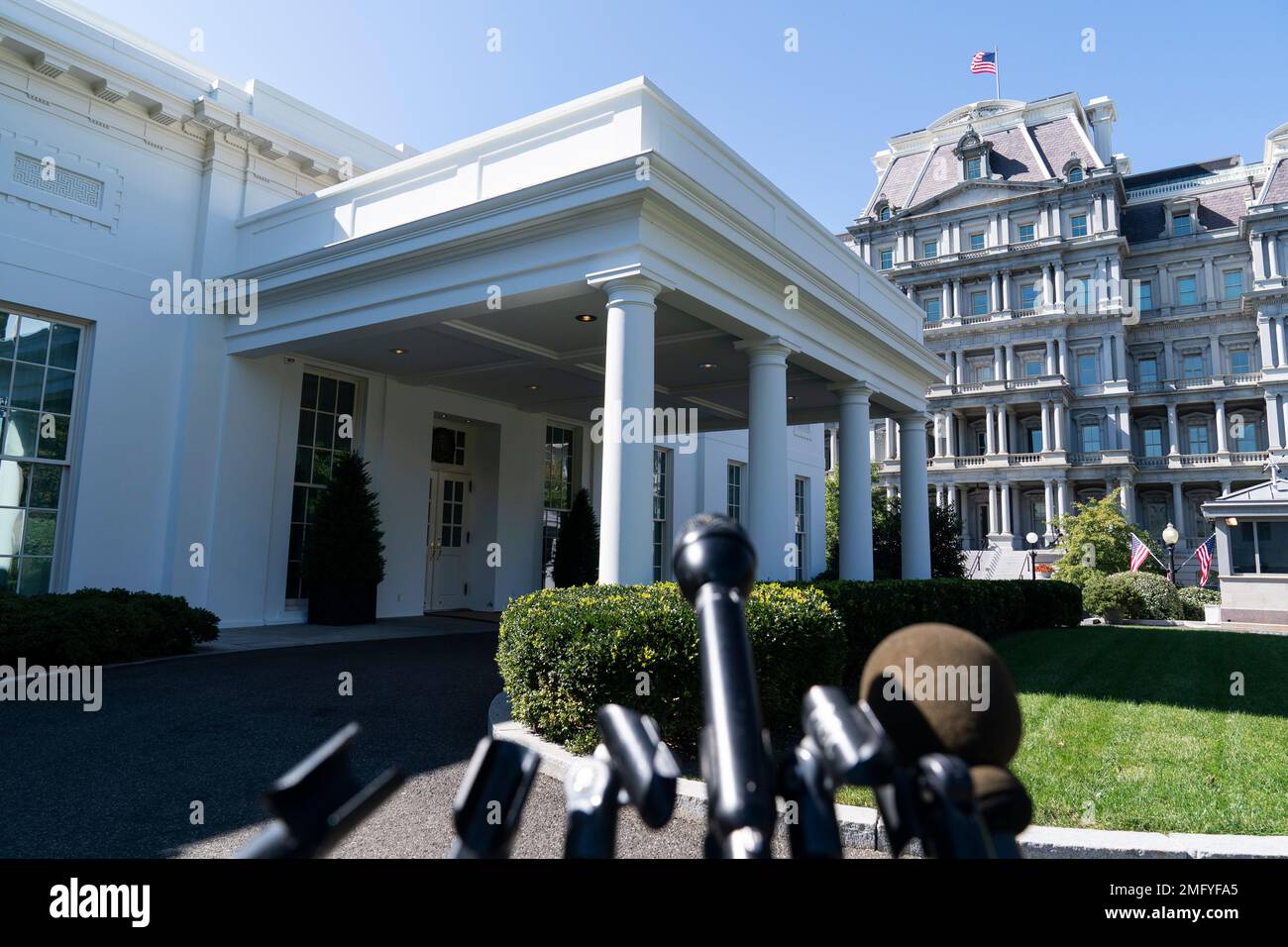 Microphones are placed in front of the West Wing of the White House and ...