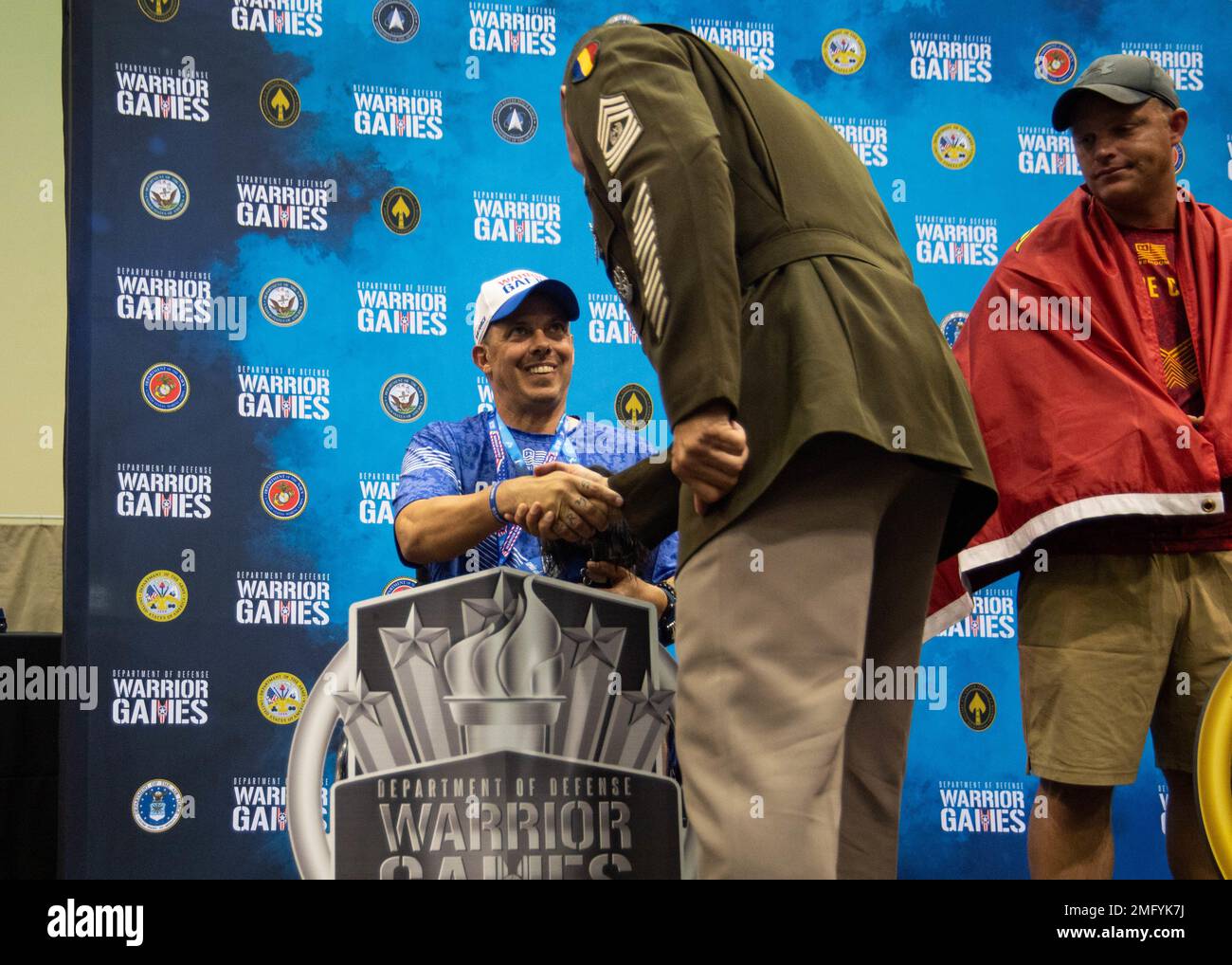 U.S. Air Force Tech. Sgt. Eric Heideman shakes hands after being ...