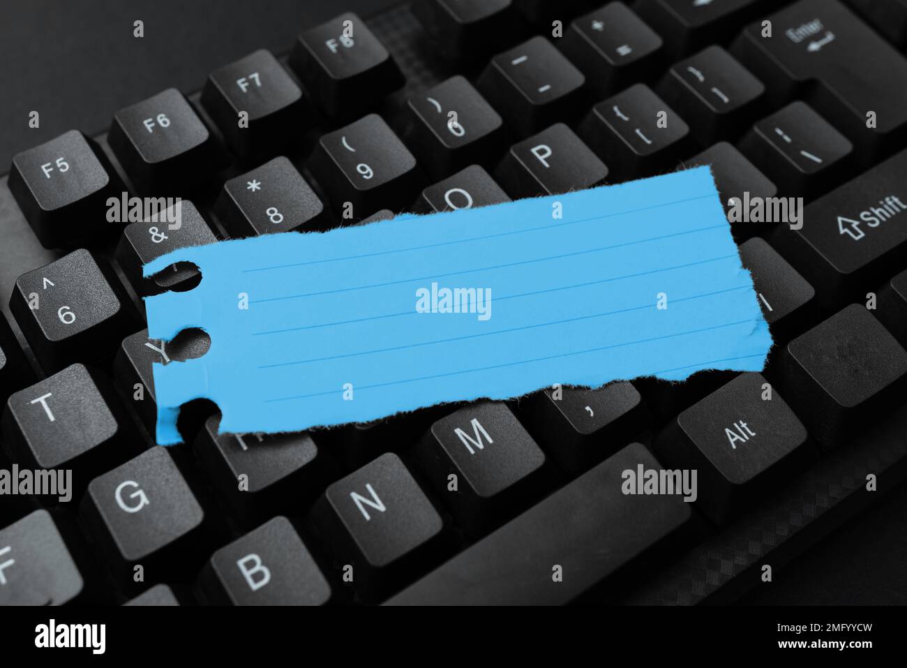 Colored sticker lying on black keyboard. Important information written ...