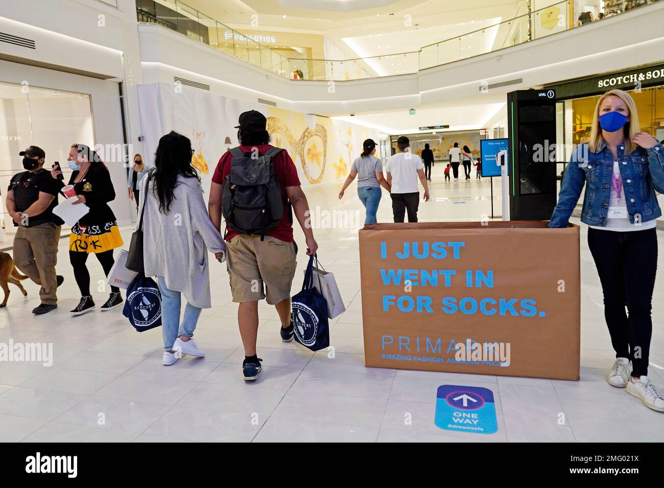 Shoppers and pedestrians walk through a shopping concourse at the ...
